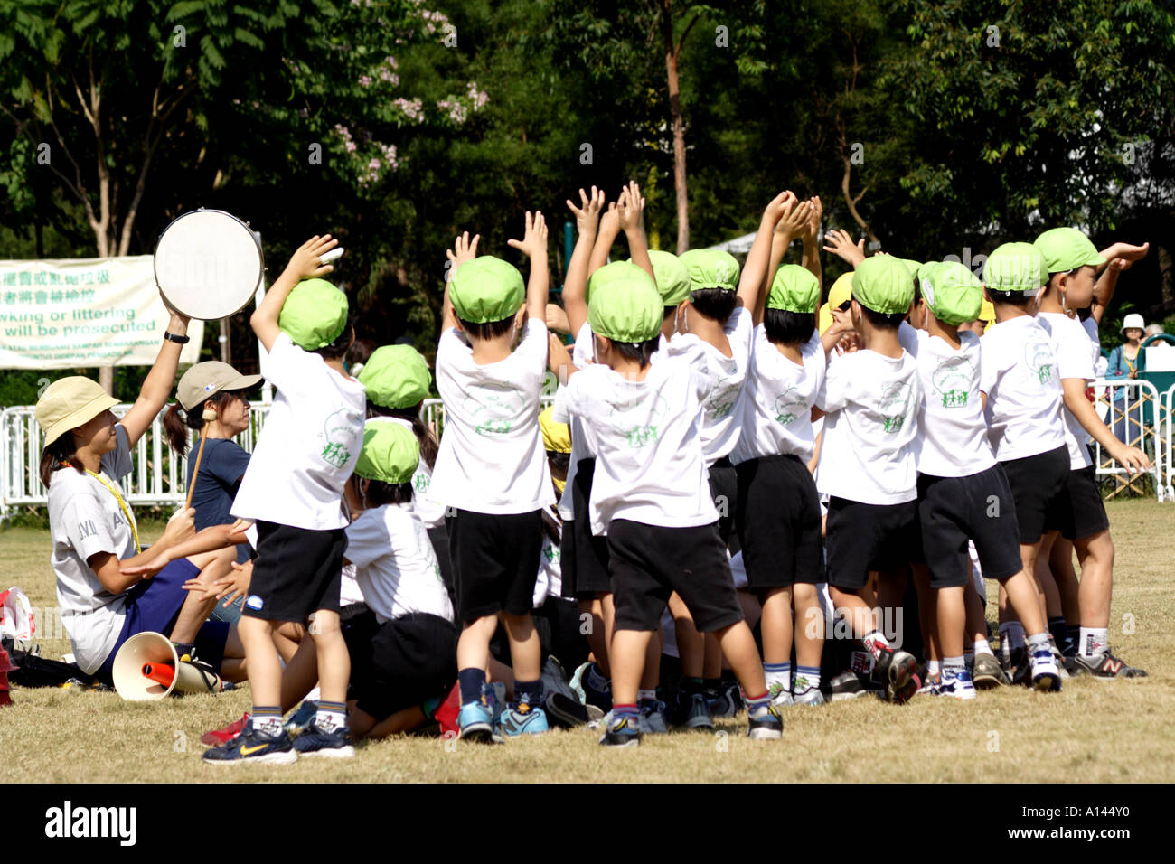 School kids in a group cheer in Victoria Park, Causeway Bay, Hong kong ...