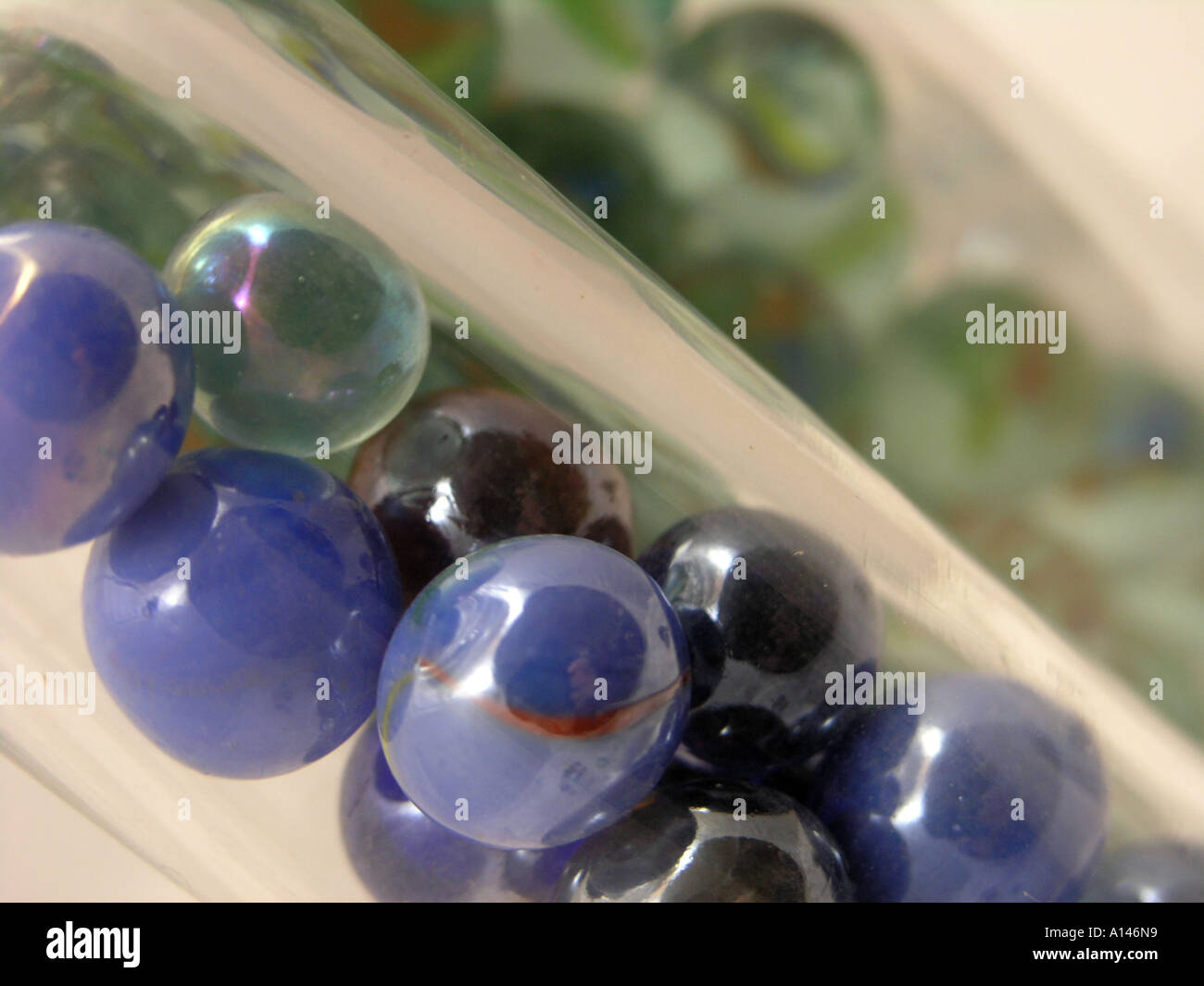 Coloured glass marbles in a tube Stock Photo - Alamy