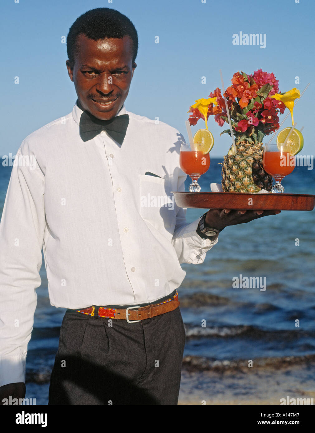 African waiter with tray hi-res stock photography and images - Alamy
