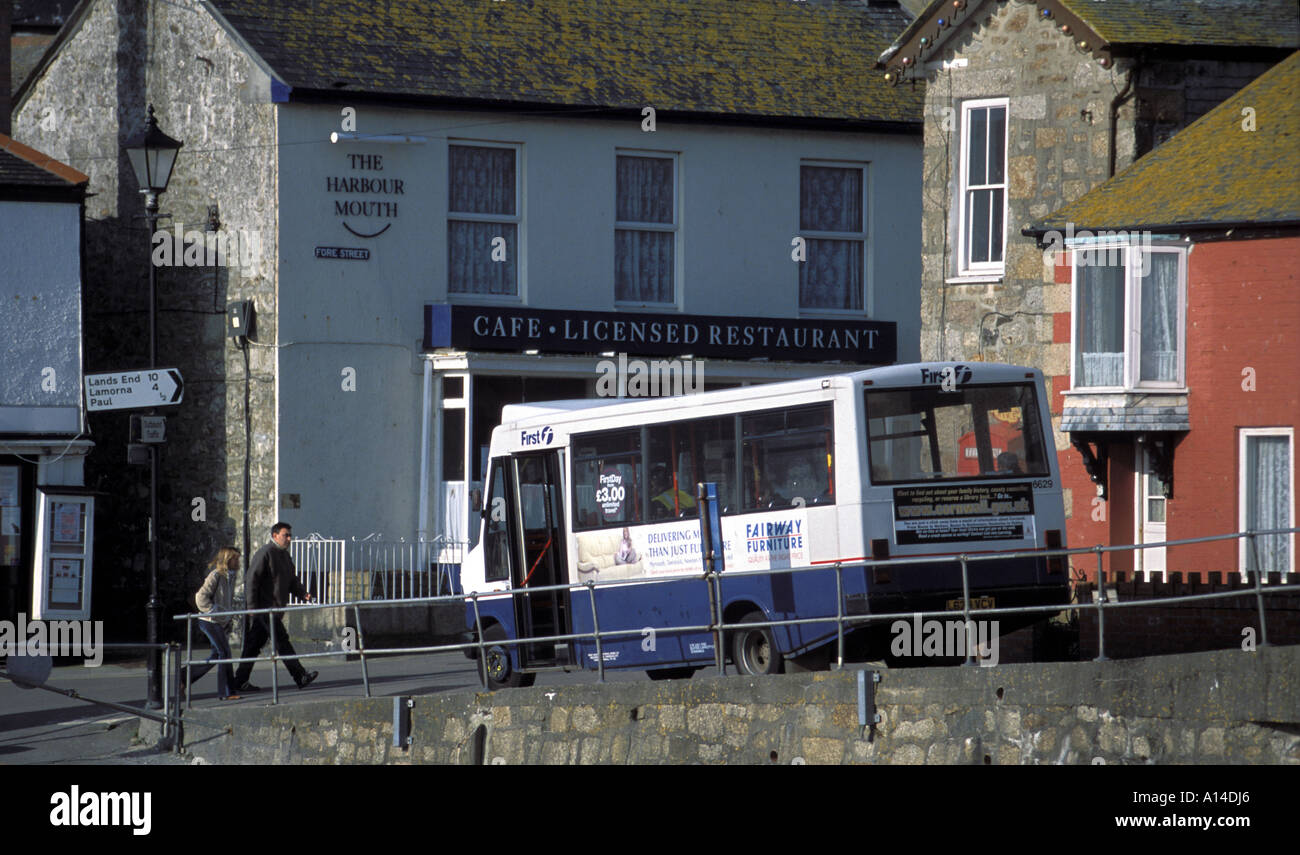 People walking to catch a bus in Mousehole near Lands End in West ...