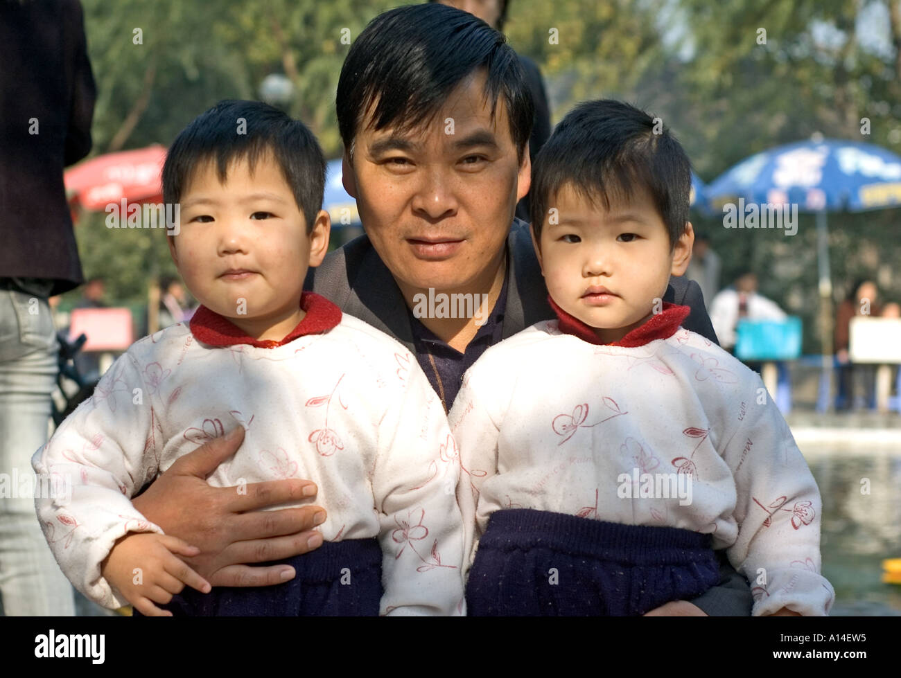 Two Chinese twin child sisters with identical clothes, posing with ...
