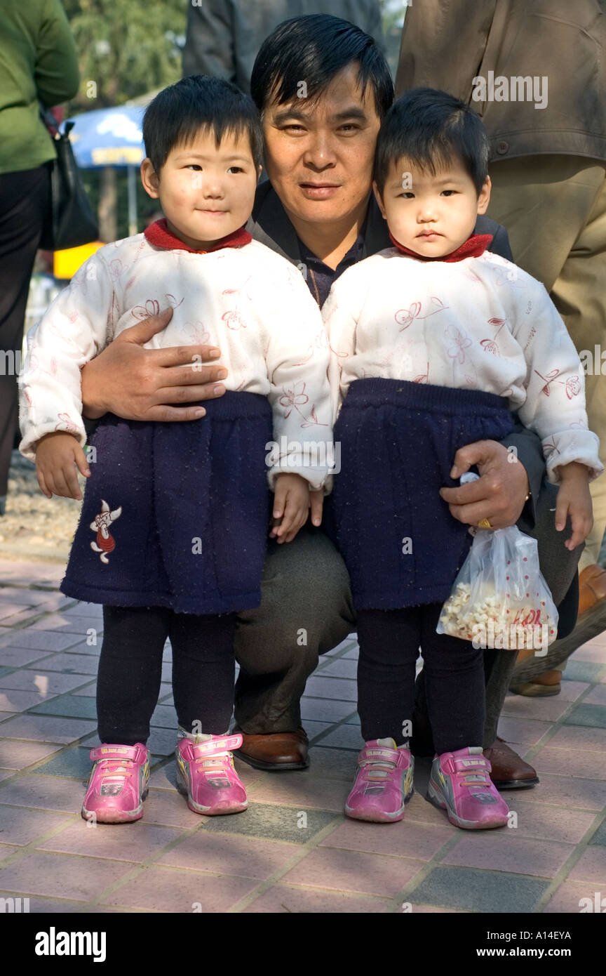 Two Chinese twin child sisters with identical clothes, posing with ...