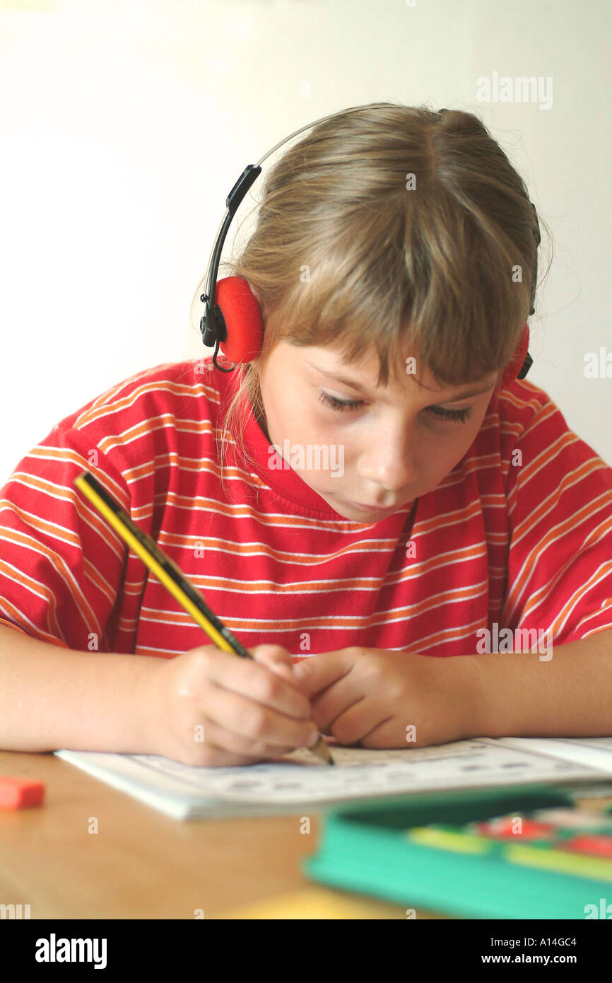 child does her homework listening to music Stock Photo - Alamy