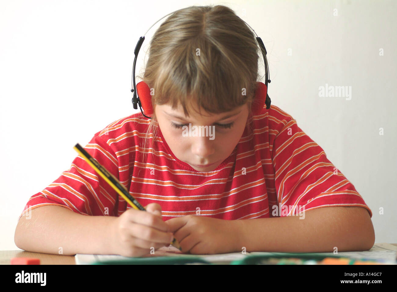 child does her homework listening to music Stock Photo - Alamy