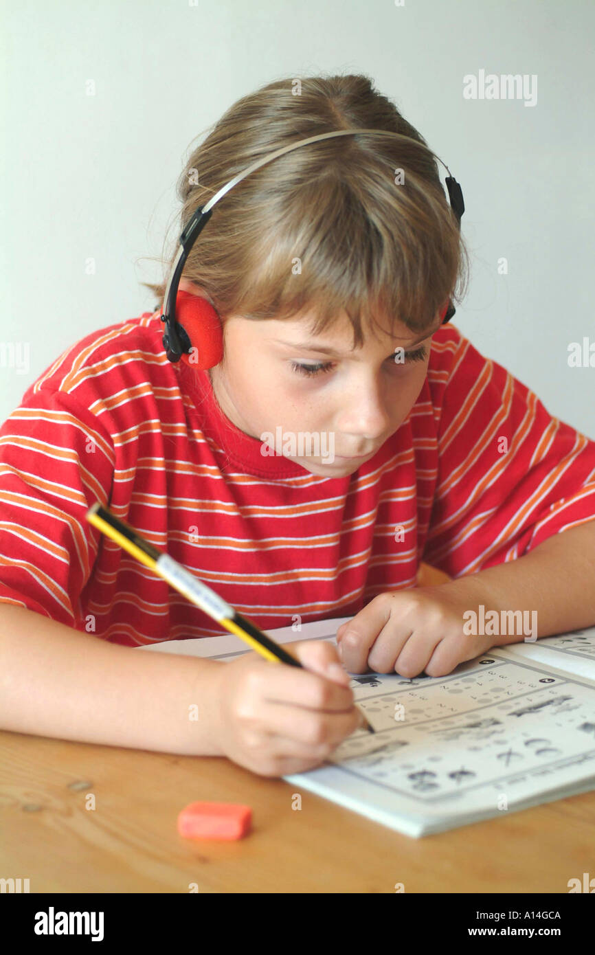child does her homework listening to music Stock Photo - Alamy