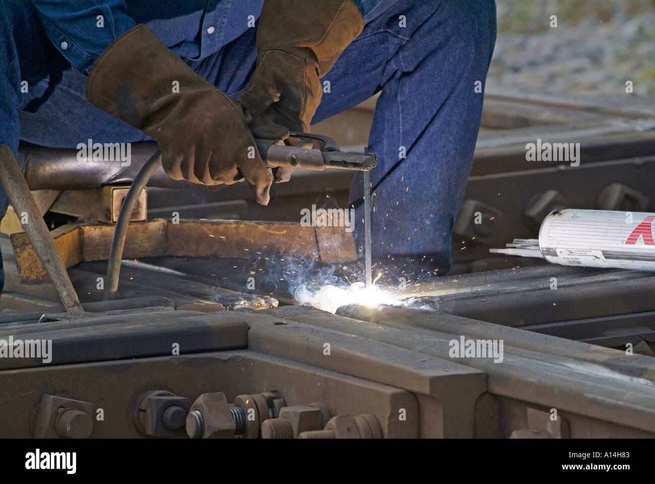 Welder performs repairs and maintenance on a section of a railroad ...