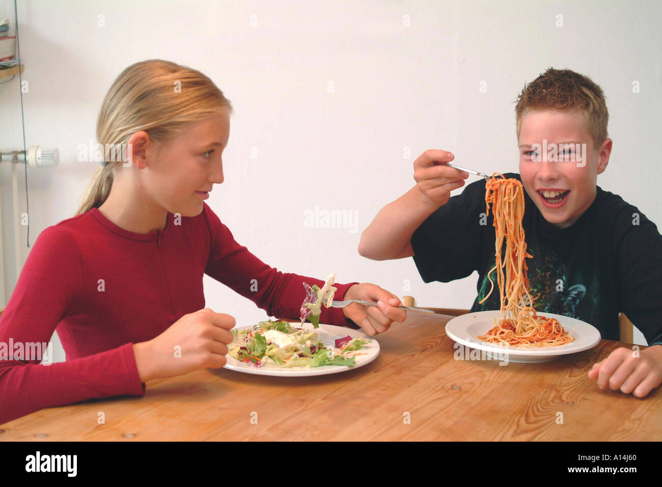 kids eating salad and fast food Stock Photo - Alamy