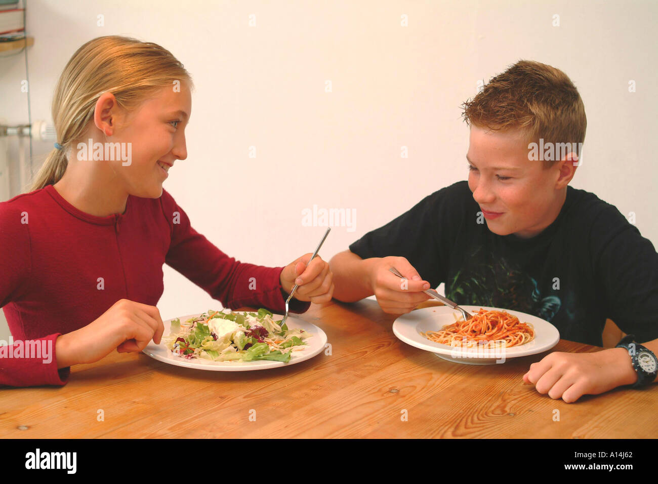 kids eating salad and fast food Stock Photo - Alamy