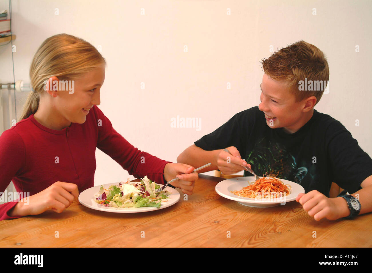 kids eating salad and fast food Stock Photo - Alamy