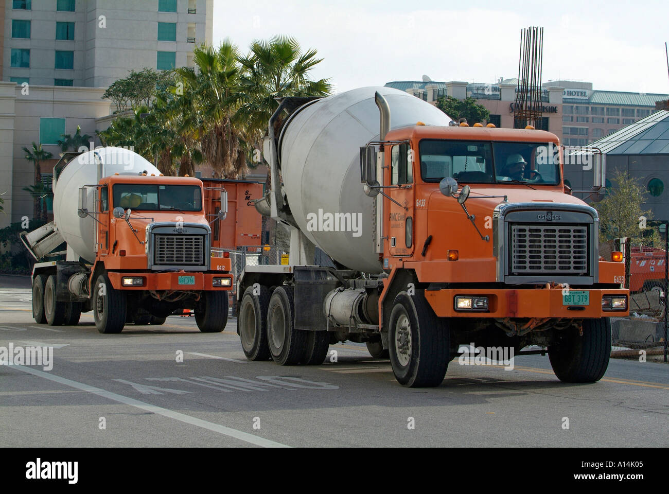 Cement hauling trucks deliver cement to building construction site in ...