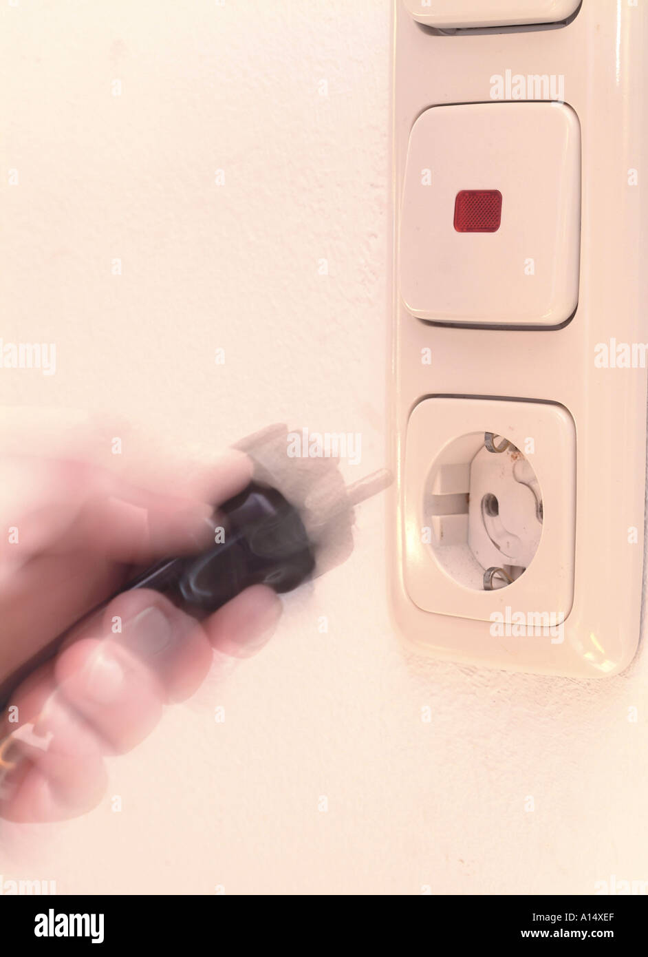 hand pulls plugs from plug socket Stock Photo - Alamy
