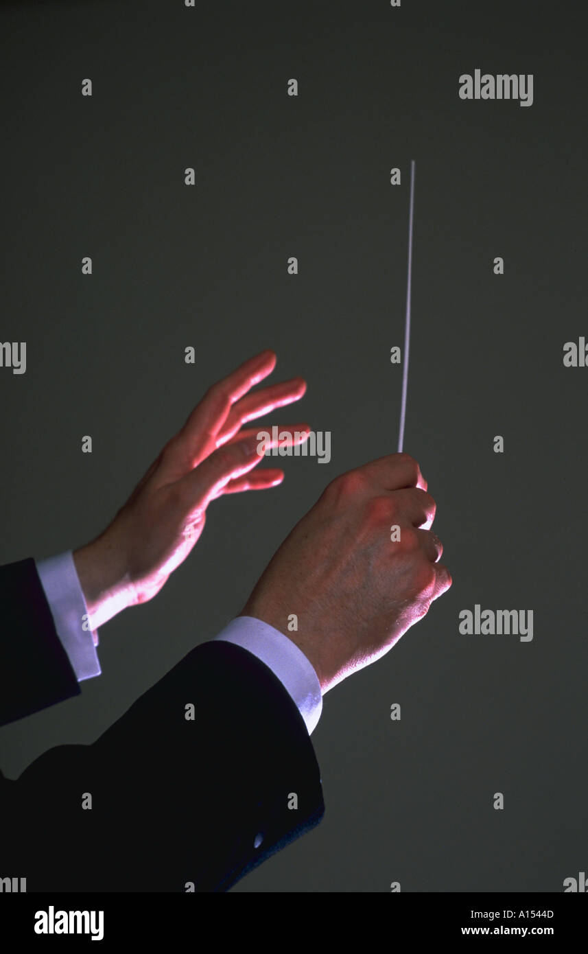 Close up of a conductors hands with a baton in one hand Stock Photo - Alamy