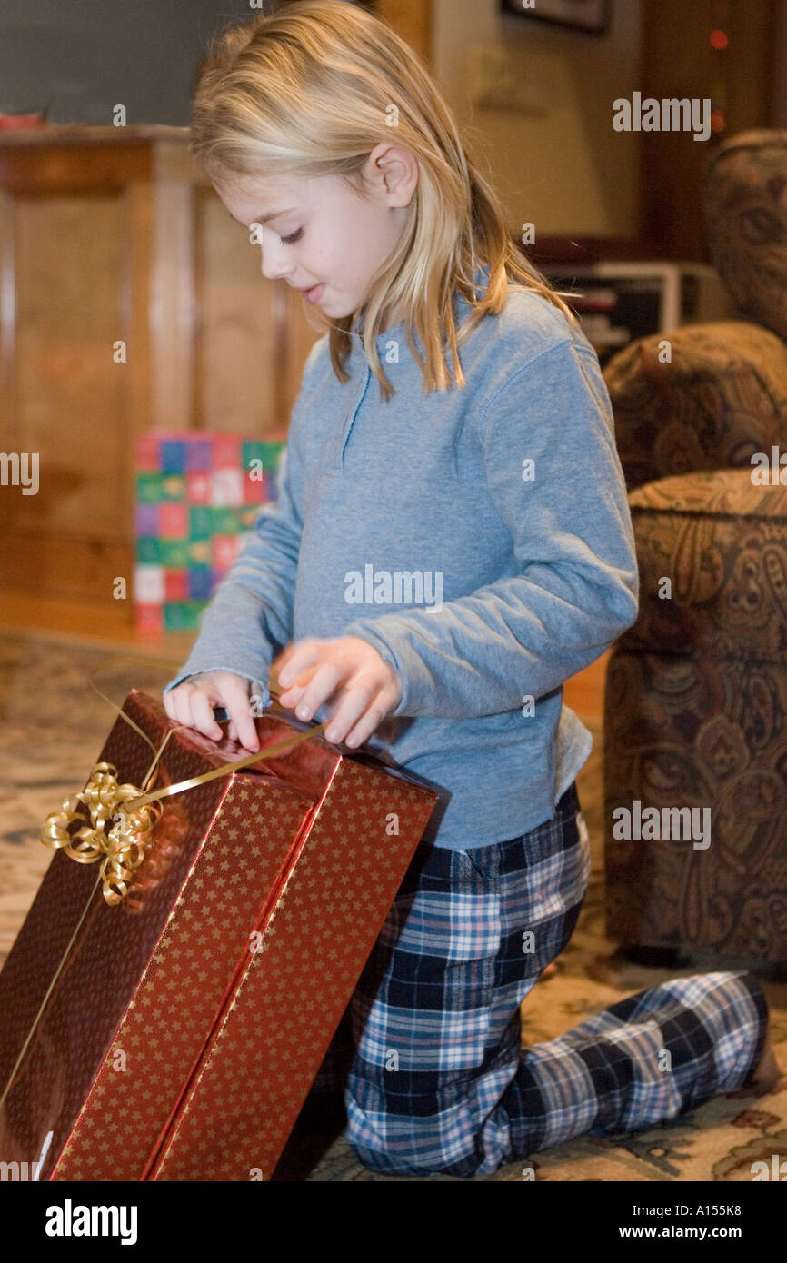 Child opening a present on Christmas morning Stock Photo - Alamy