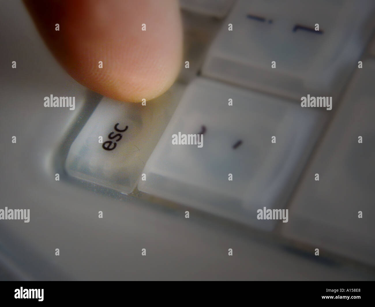 Finger pressing Esc key on computer keyboard David Hughes Stock Photo ...