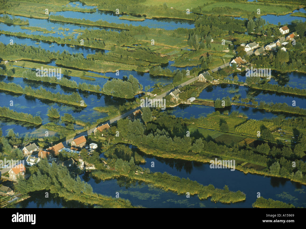 Aerial of a road across a landscape of water and tree lined embankments ...