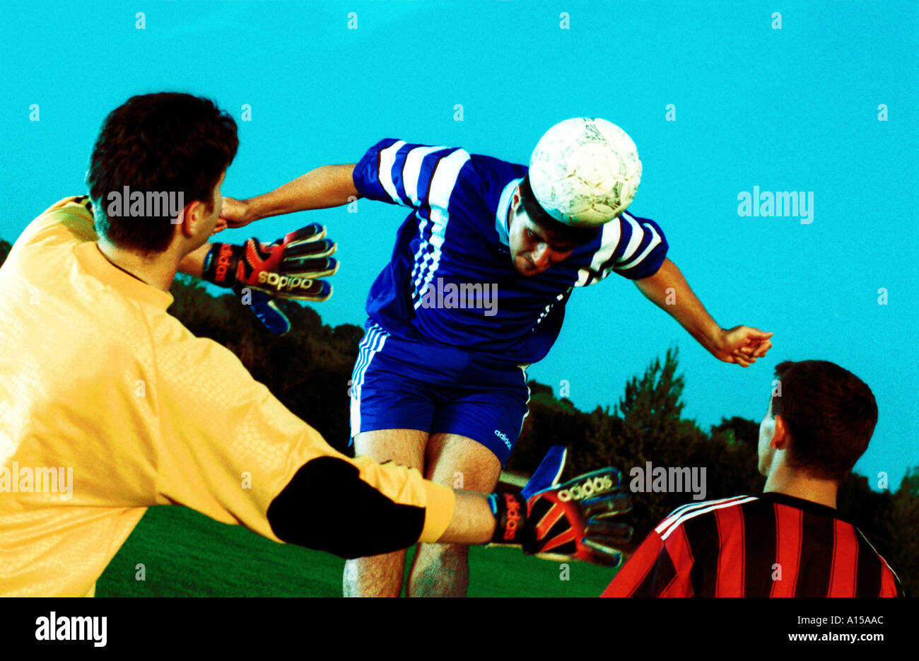 soccer young men playing football Stock Photo - Alamy