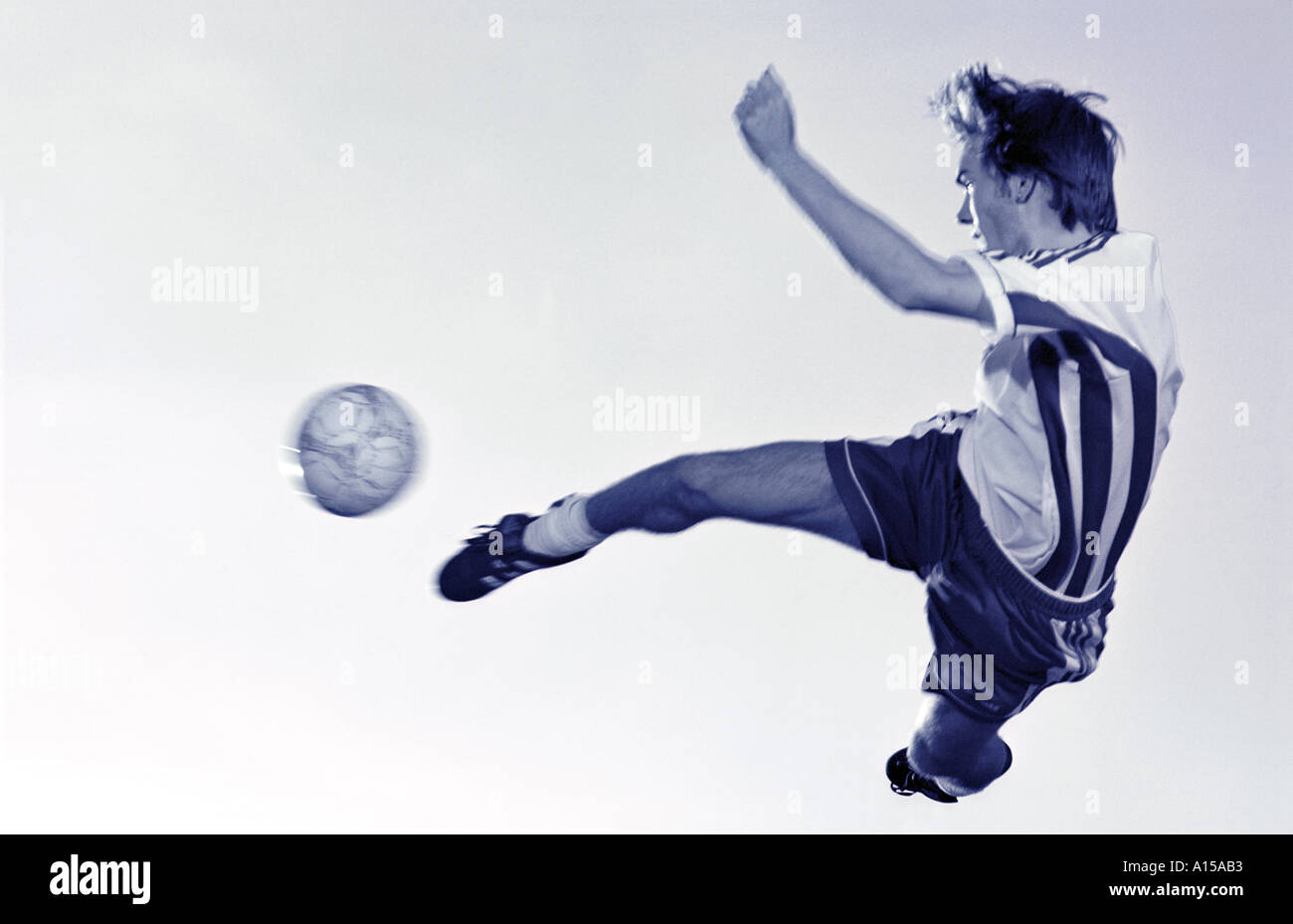 soccer young man playing football Stock Photo - Alamy