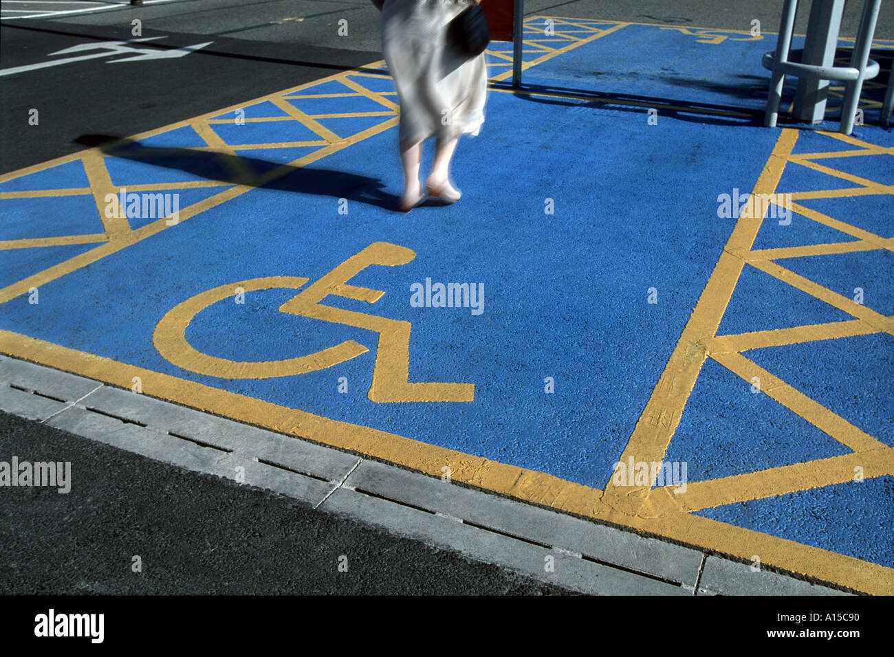 Disabled parking space sign car park person moving across space Stock ...