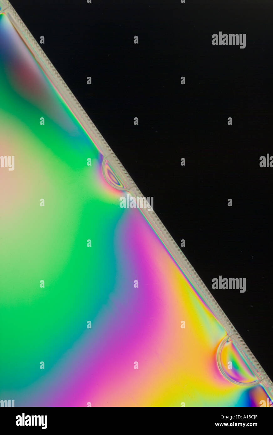 Cross polarised light showing stress patterns in plastic Stock Photo ...