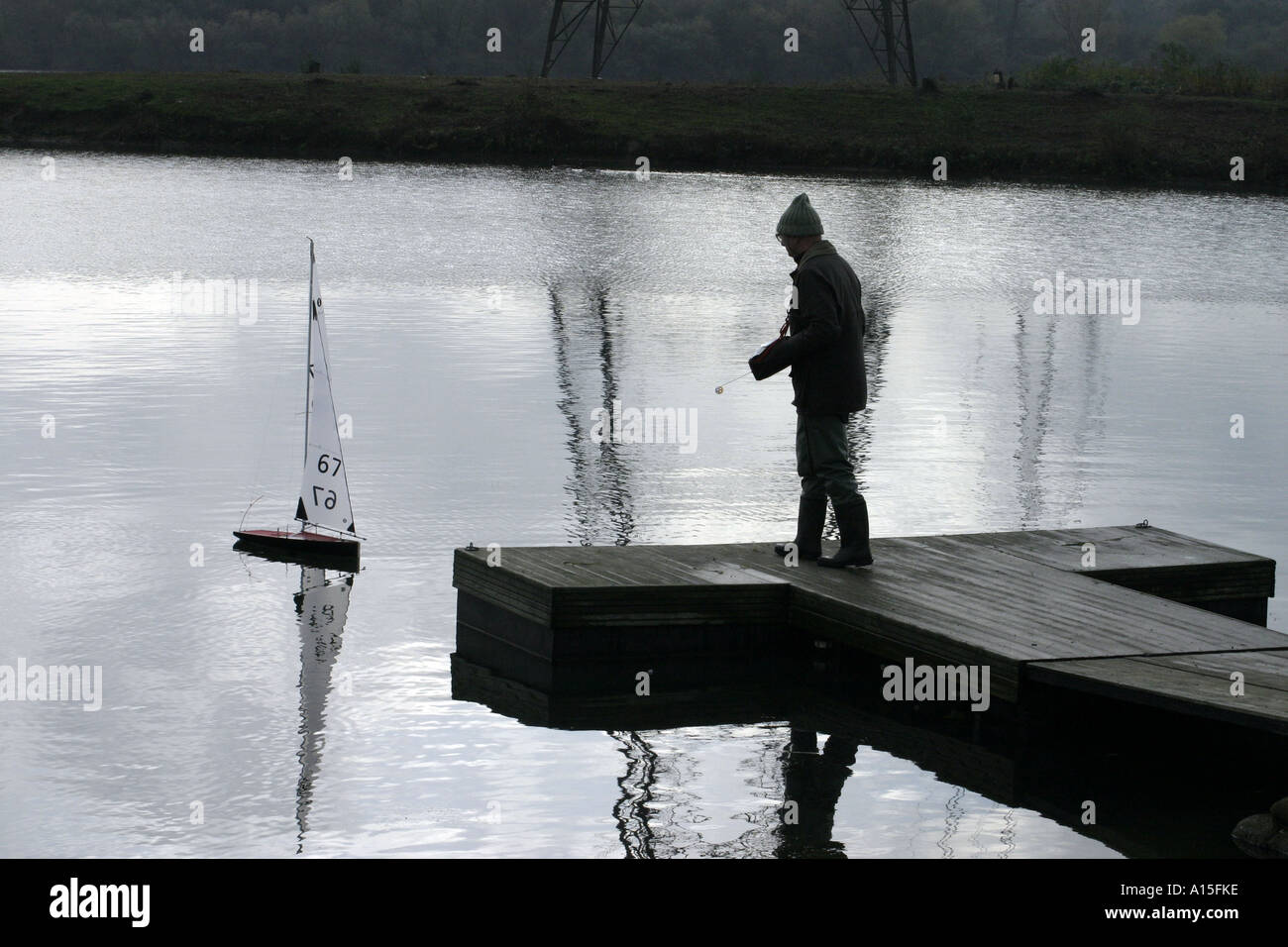 Man sailing his model yacht Stock Photo - Alamy