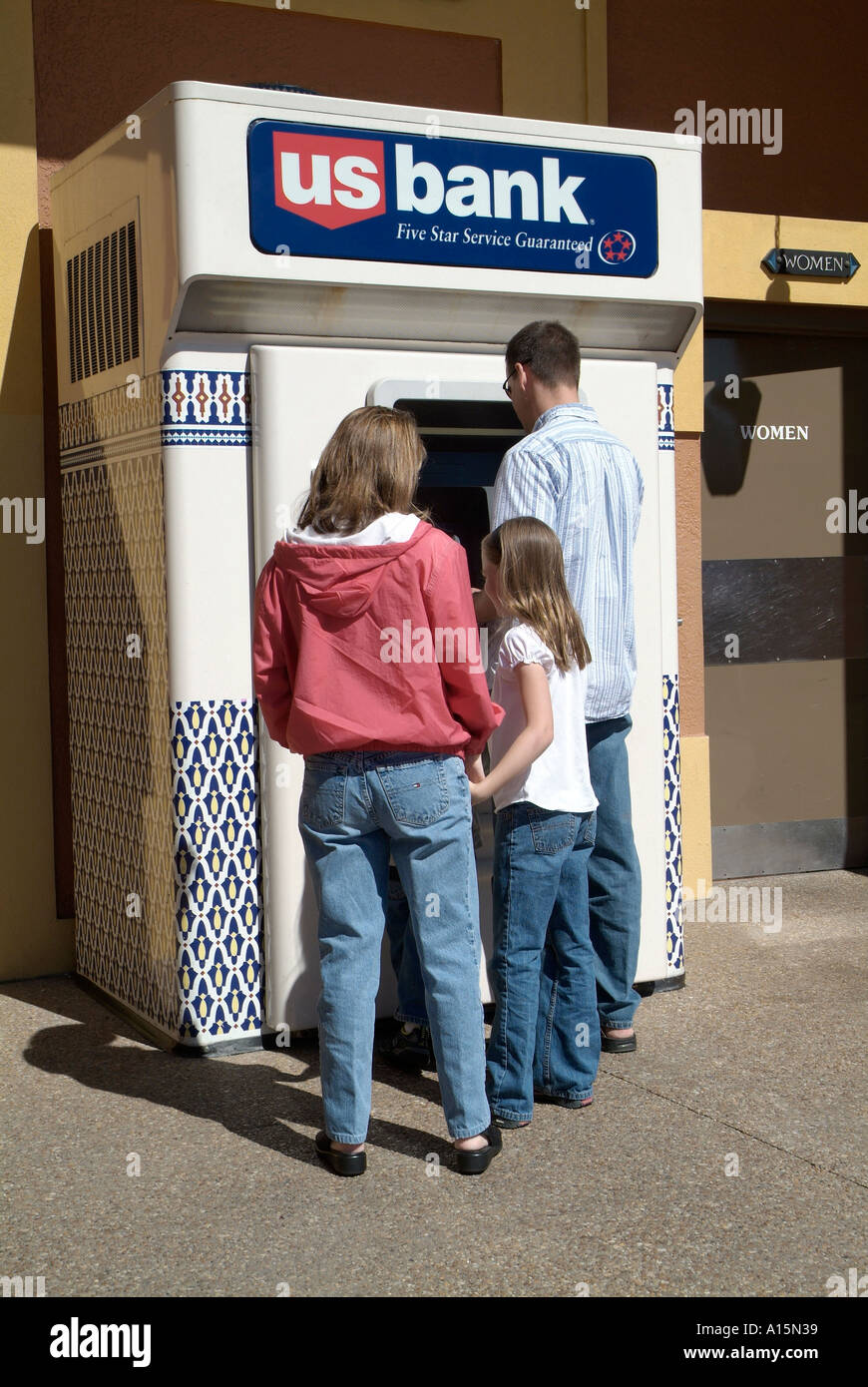 People drawing money from an ATM machine Stock Photo - Alamy
