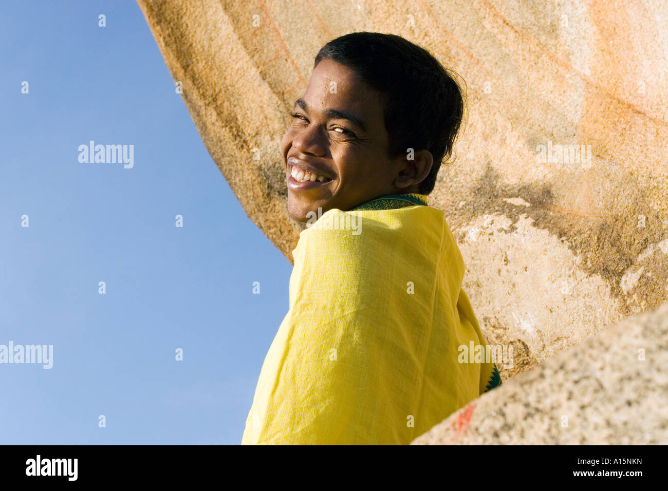 Young brahmachari Indian boy laughing next to shiva lingam at Lepakshi ...