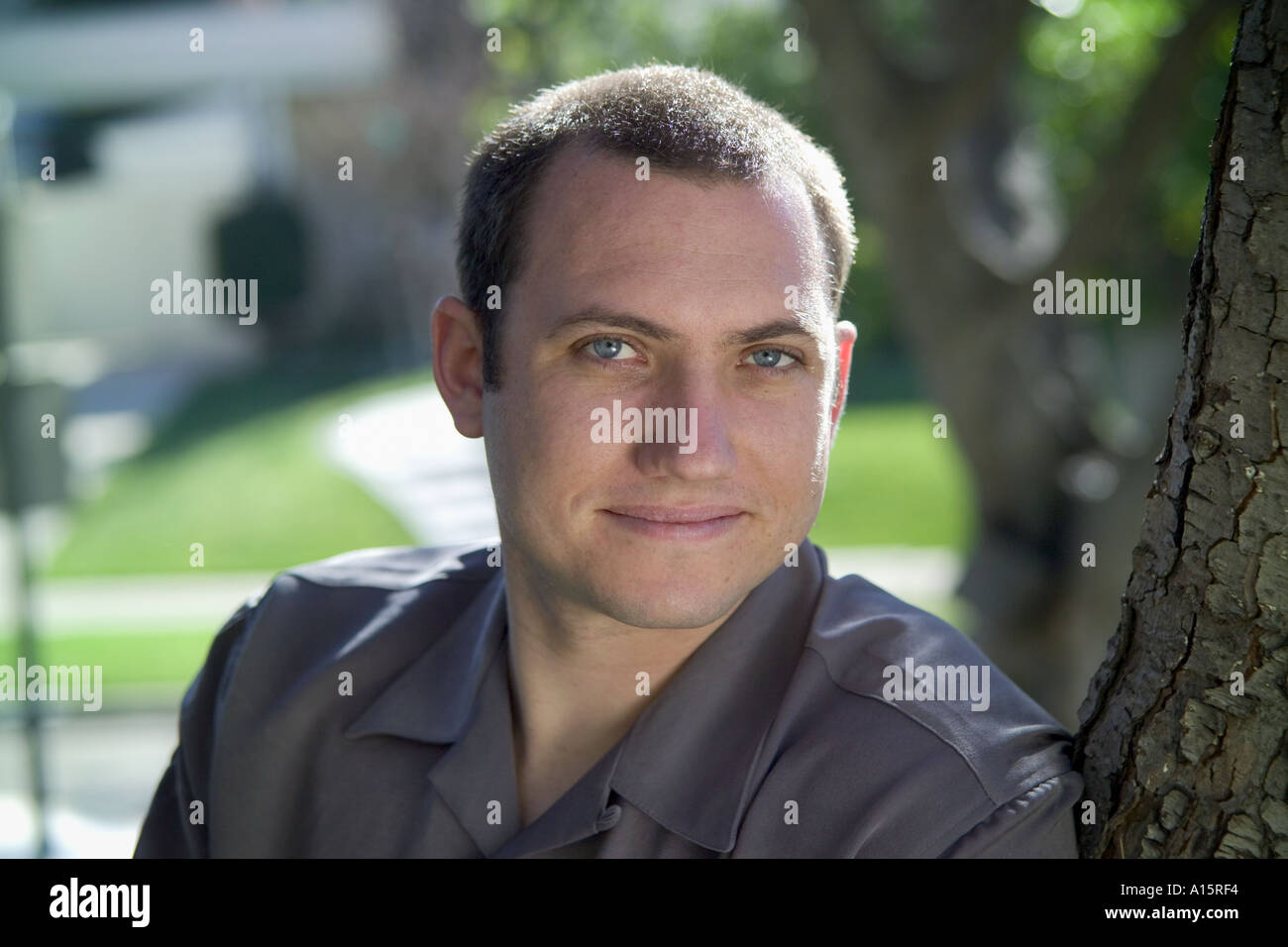 White Caucasian male in 20 to 30 year range smiles quietly in portrait ...