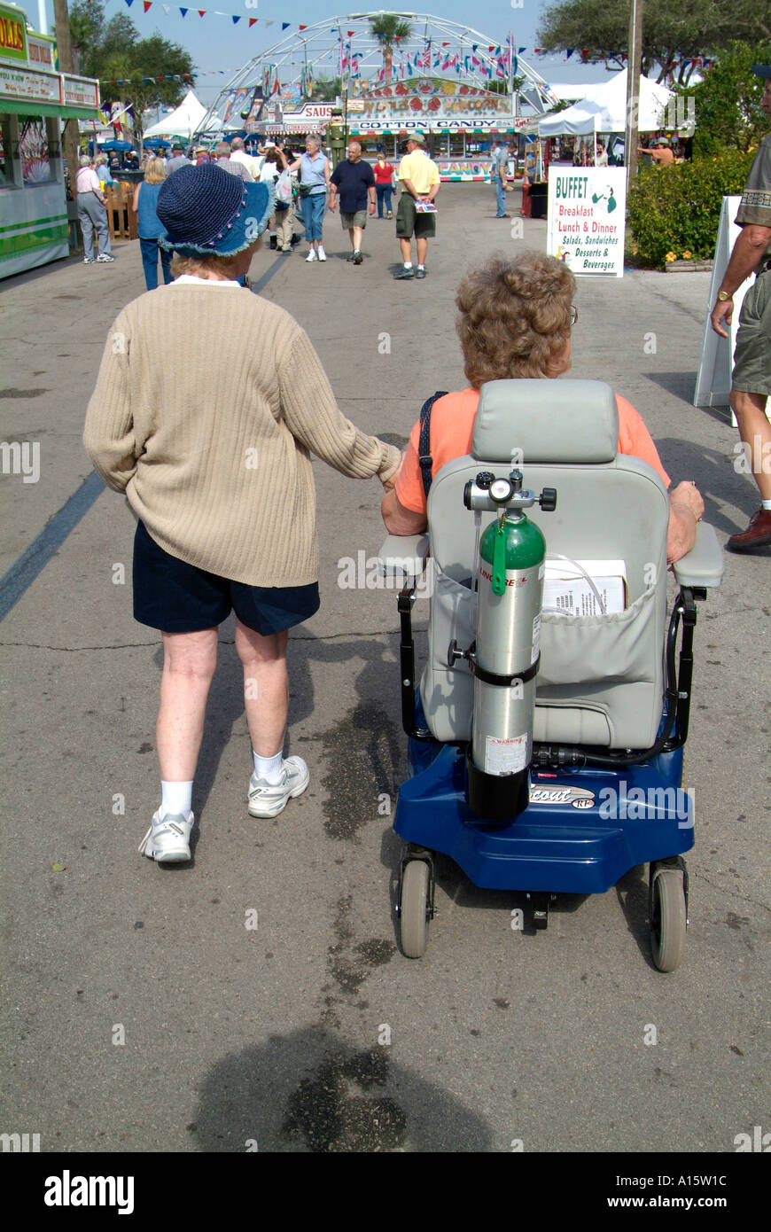 Handicapped person with oxygen tank in motorized wheelchair Stock Photo ...