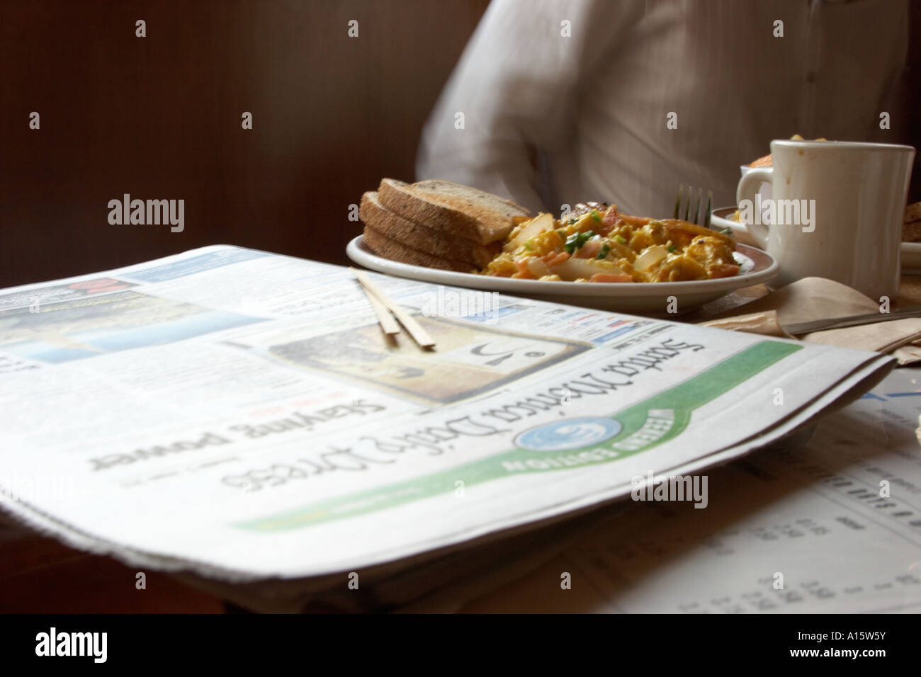 A morning scene of a man getting up from on the table strewn with his ...