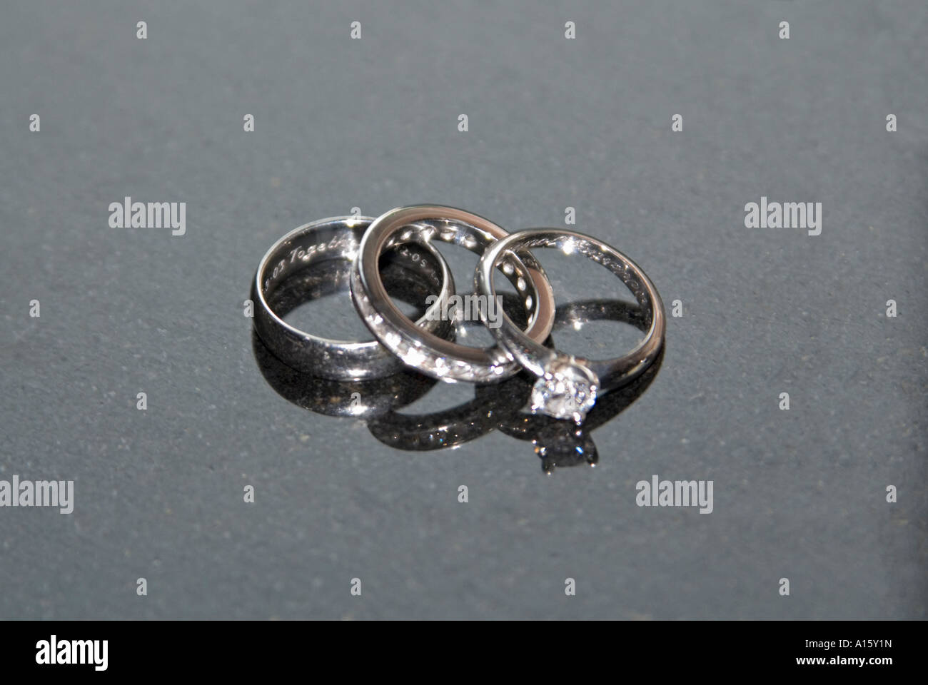 Horizontal close up of the Bride and Groom's platinum wedding bands and ...