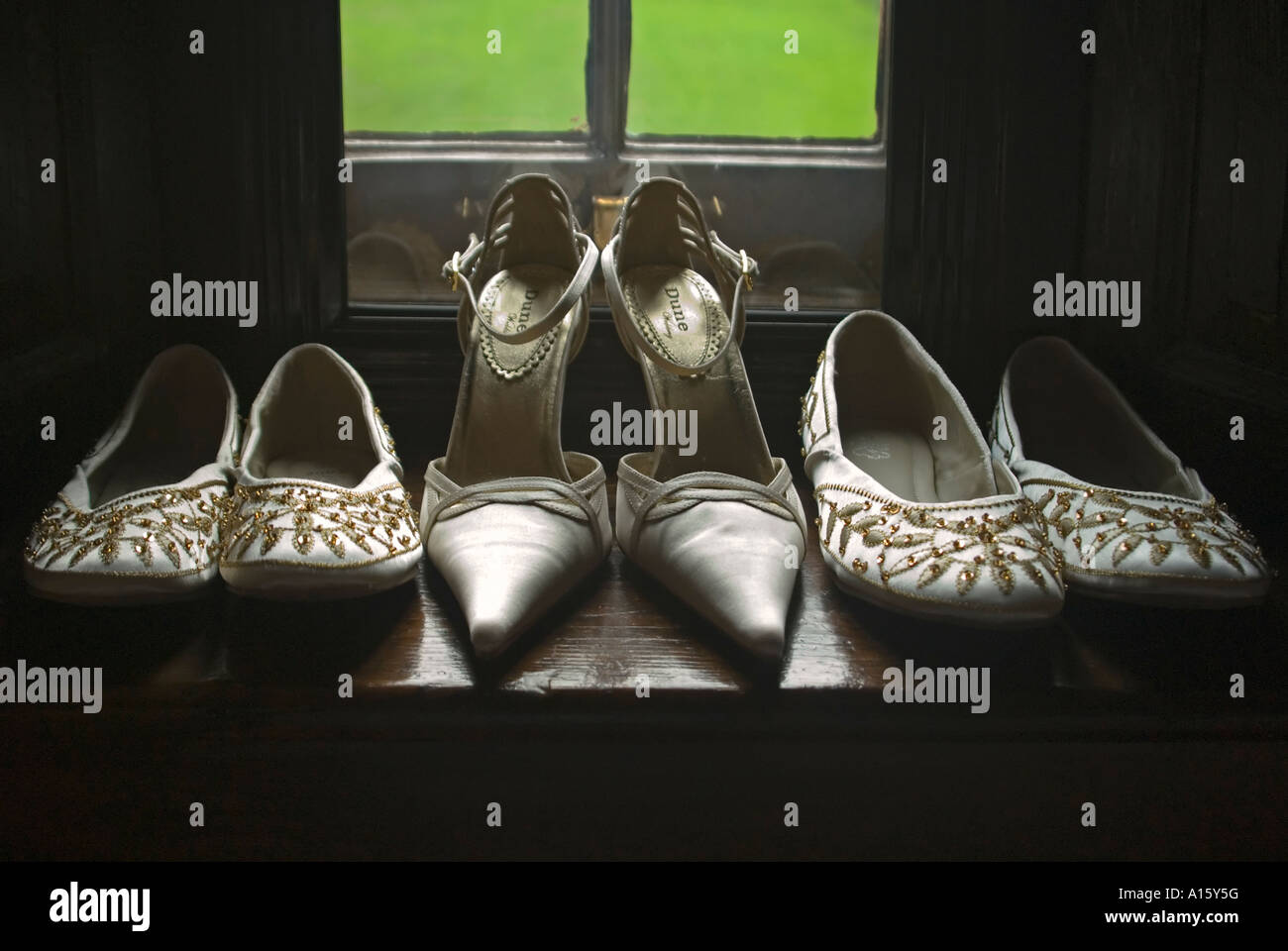 Horizontal close up of the brand new bridal shoes and bridesmaids ...