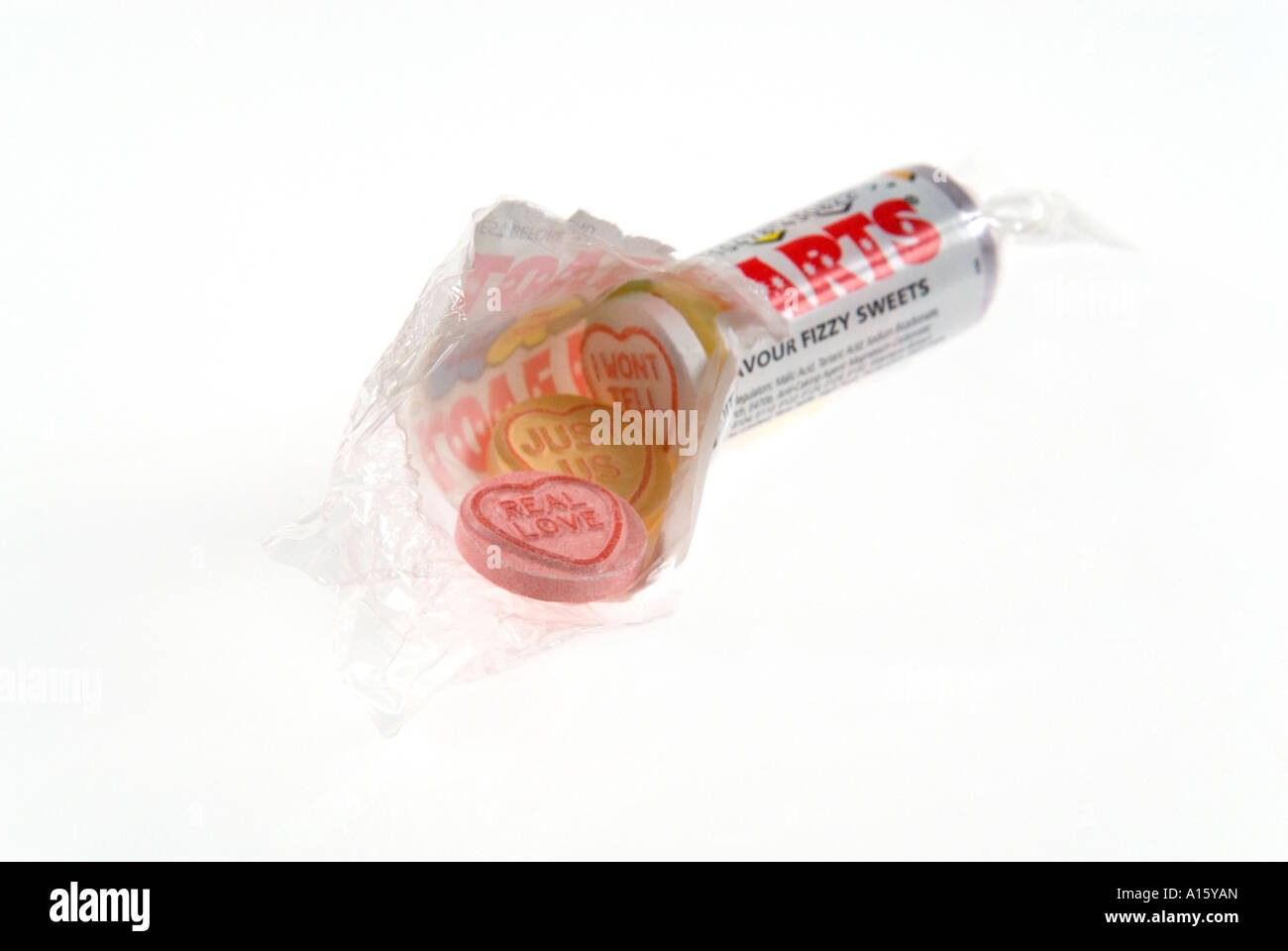 Horizontal close up of an unwrapped packet of loveheart sweets on a ...