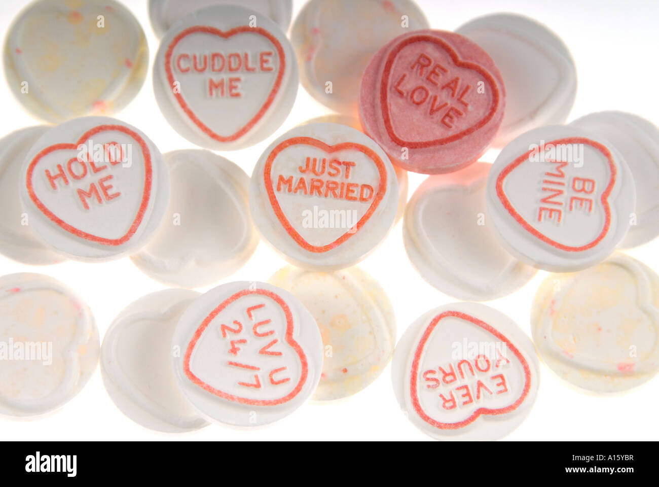 Horizontal elevated close up of a pile of white loveheart sweets with ...