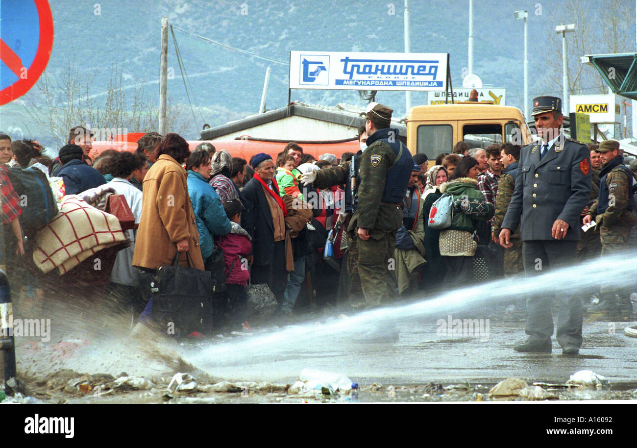 Macedonian police clean the road where ethnic Albanian refugees from ...