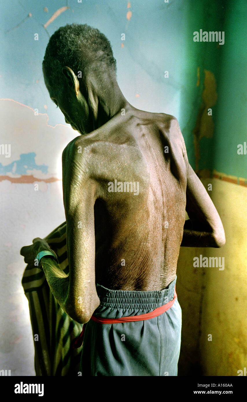 An Angolan child stands in one of the many destroyed buildings in the ...