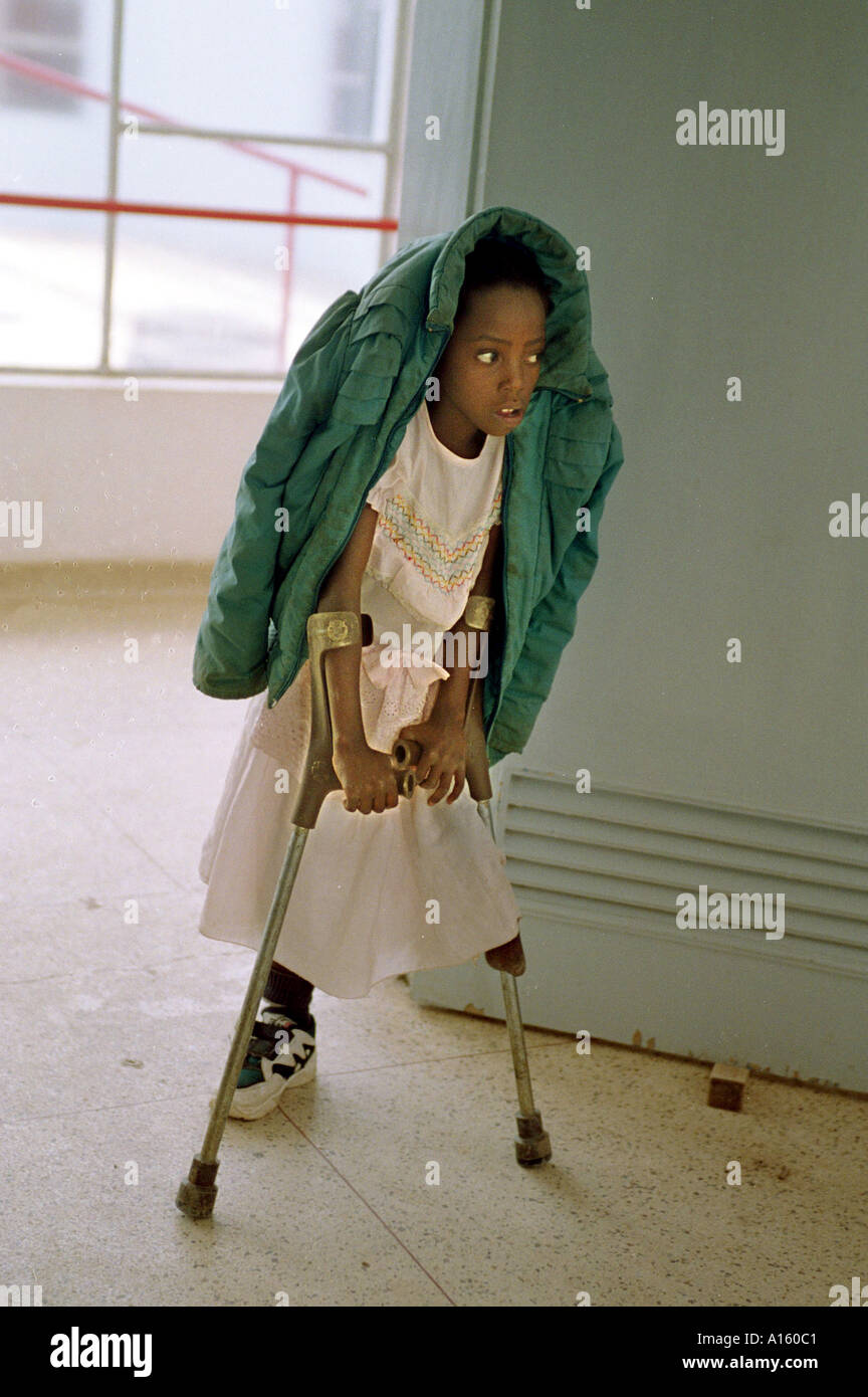 An Angolan child practices walking on crutches at the International Red ...