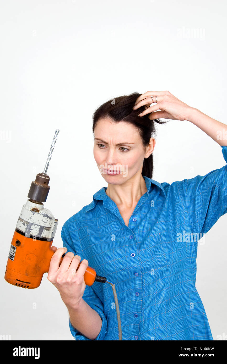 Woman tool at home drill Cut Out Stock Images & Pictures - Alamy