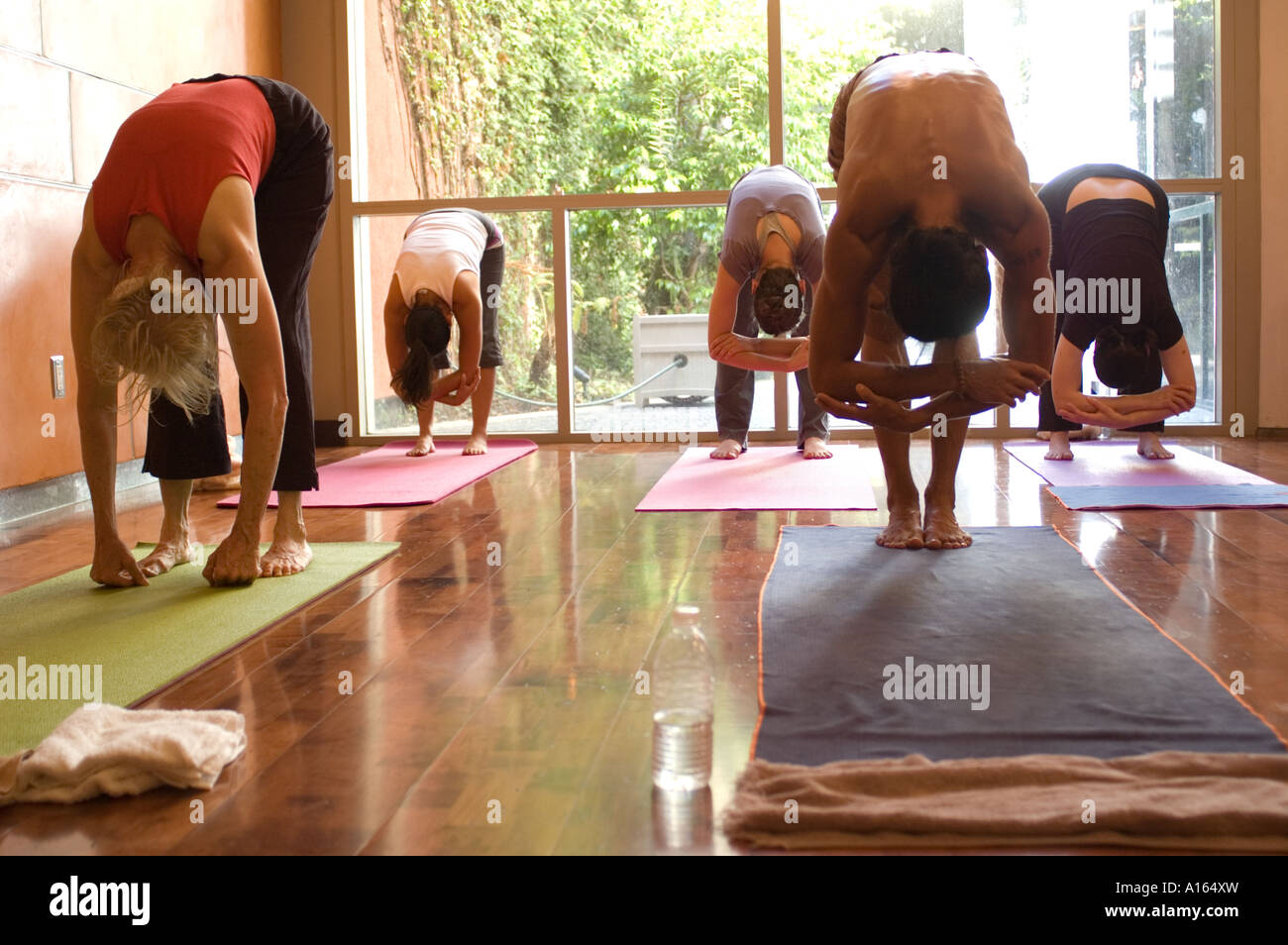 Group practicing yoga indoors Stock Photo - Alamy
