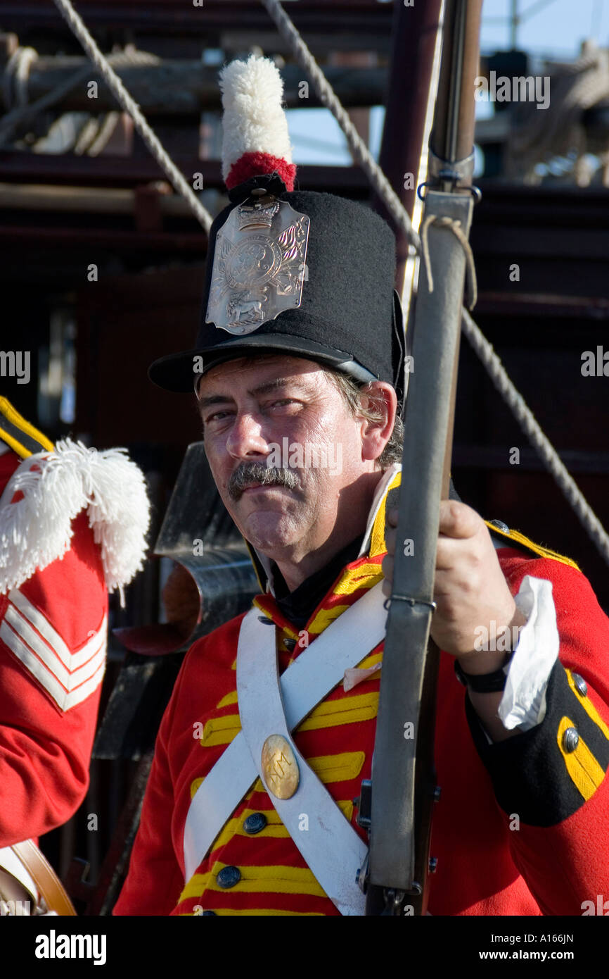 Man dressed as 18th century British redcoat, musket in hand, aboard the ...