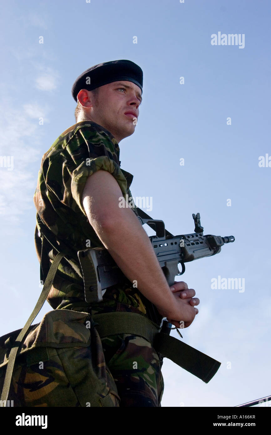 Armed navy marine stands guard aboard HMS Atherstone during maritime ...
