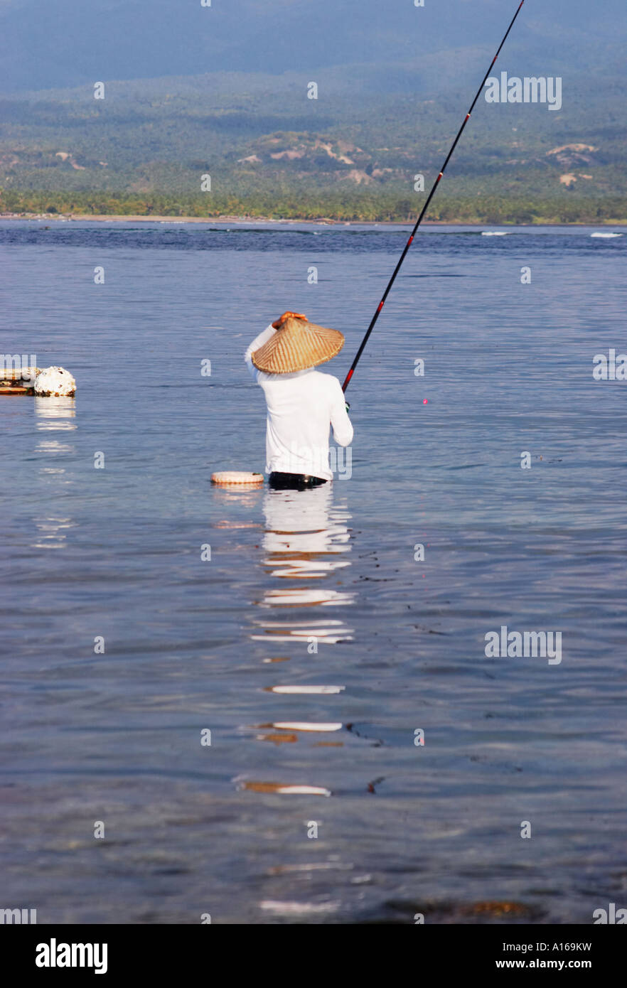 Man Standing In Sea Fishing Stock Photo - Alamy