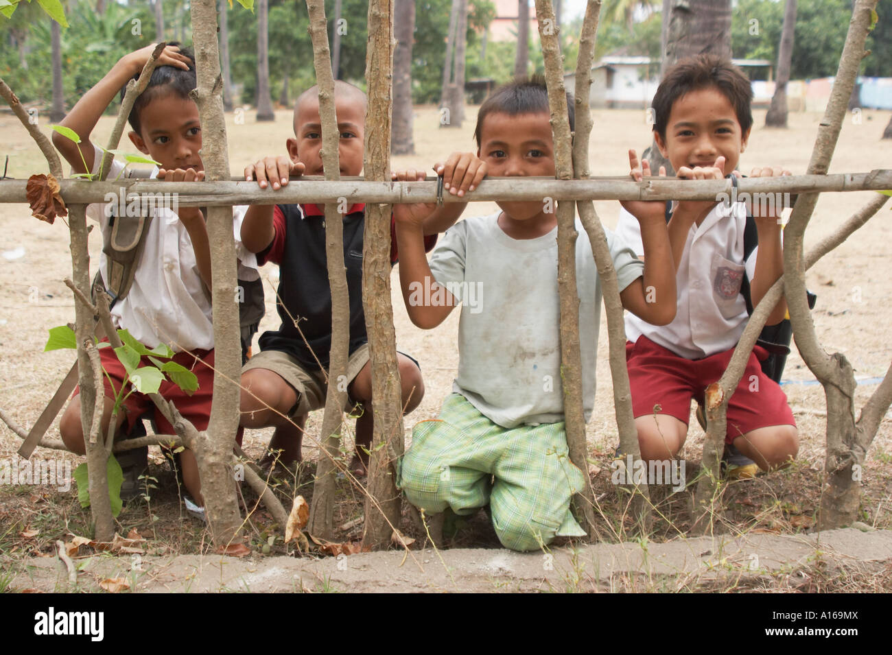 Boys Posing Behind Fence Stock Photo - Alamy