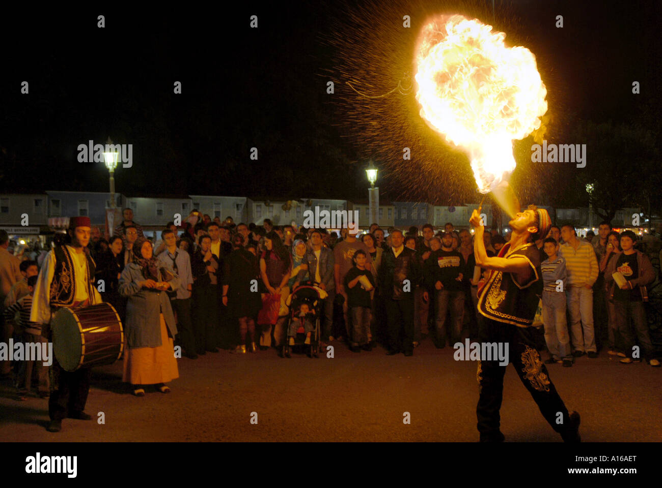 TURKISH SHOWMAN BLOWING FIRE,HIS MOUTH FULL OF FIRE LIQUID,DURING ...