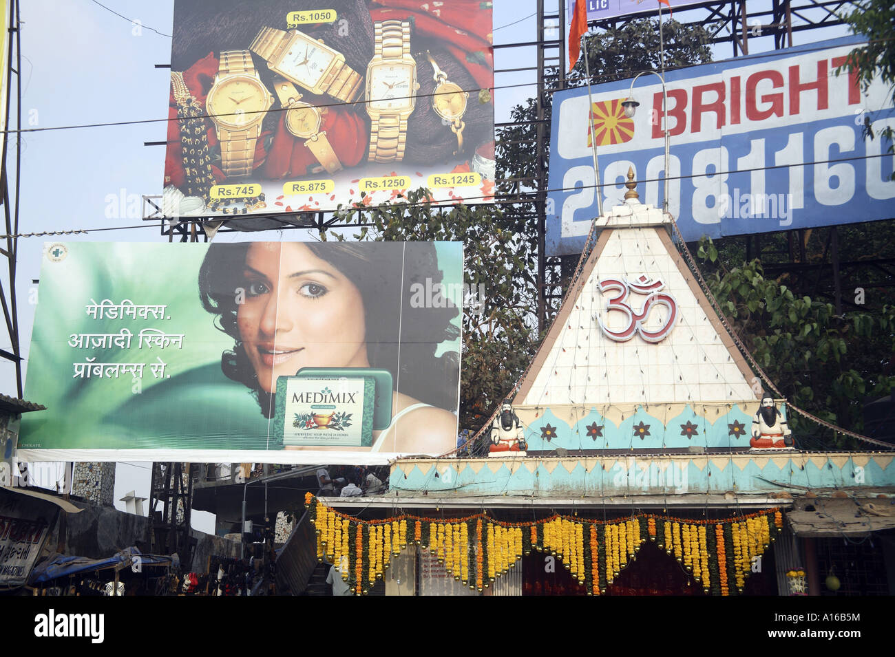 Indian street Hindu temple with OM written surrounded by modern ...