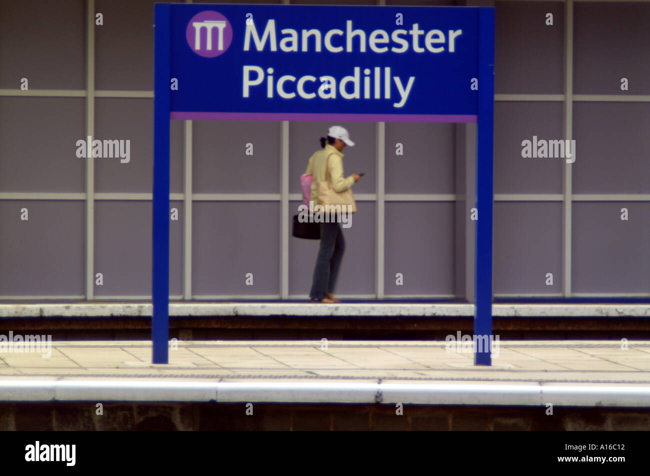 Manchester Piccadilly train station sign woman with mobile phone Stock ...