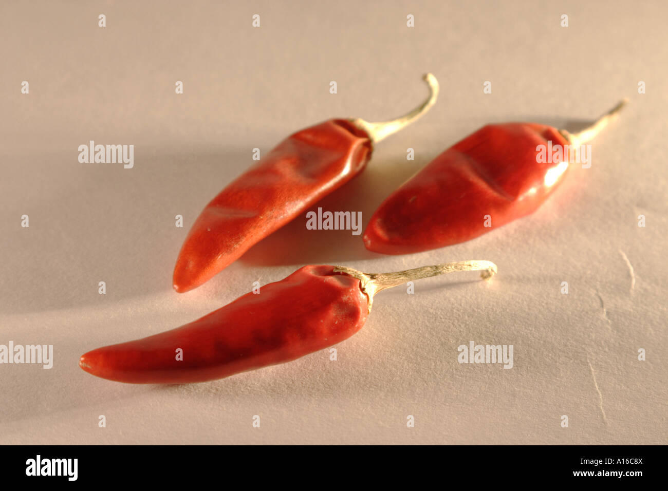 Three red chillies hi-res stock photography and images - Alamy
