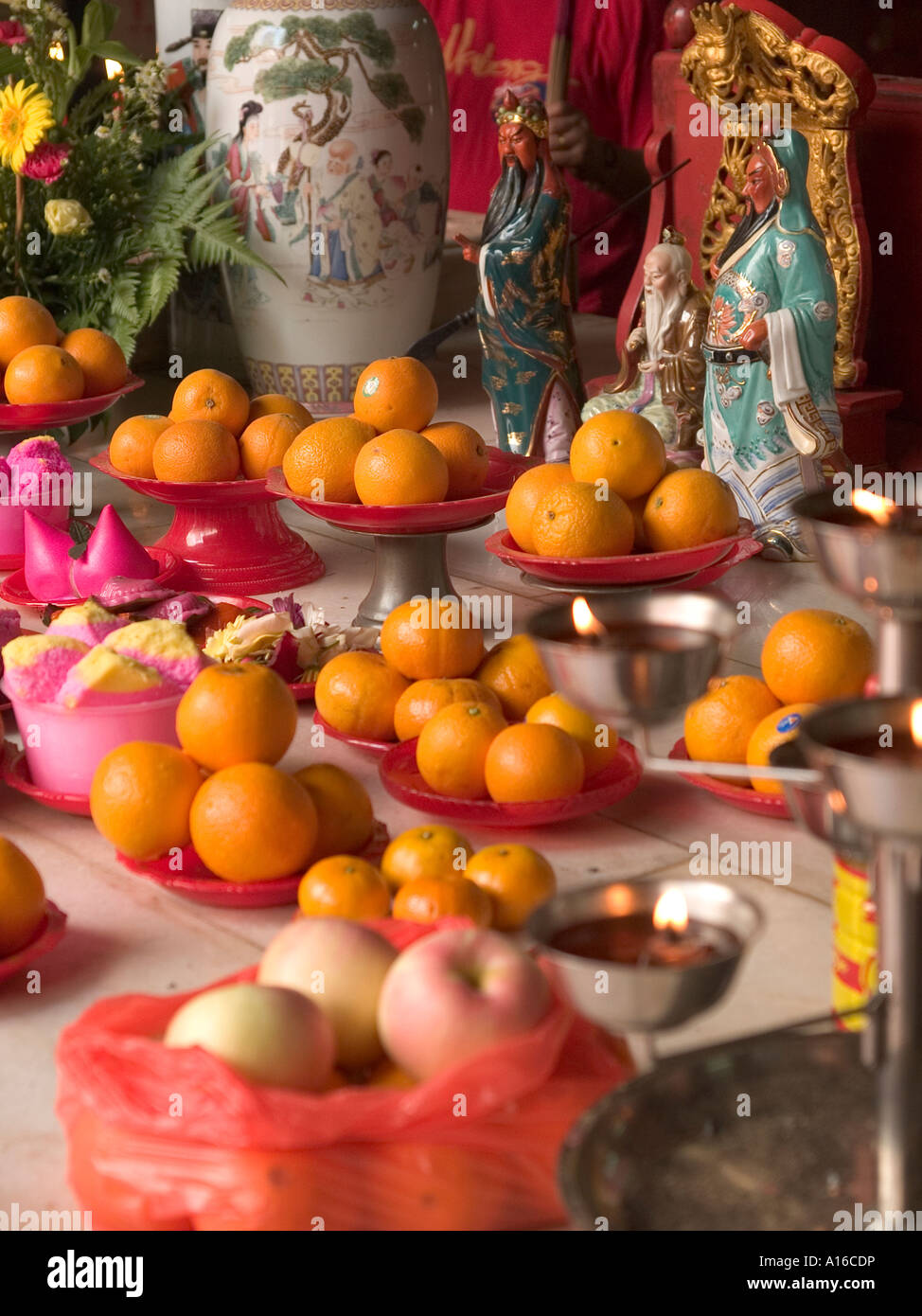 Oranges and red cakes used as offerings by devotees at the Nan Thien ...