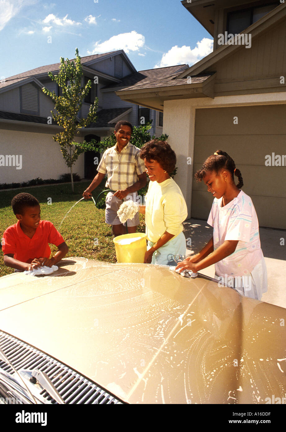 Black African American family washing the car together Stock Photo - Alamy