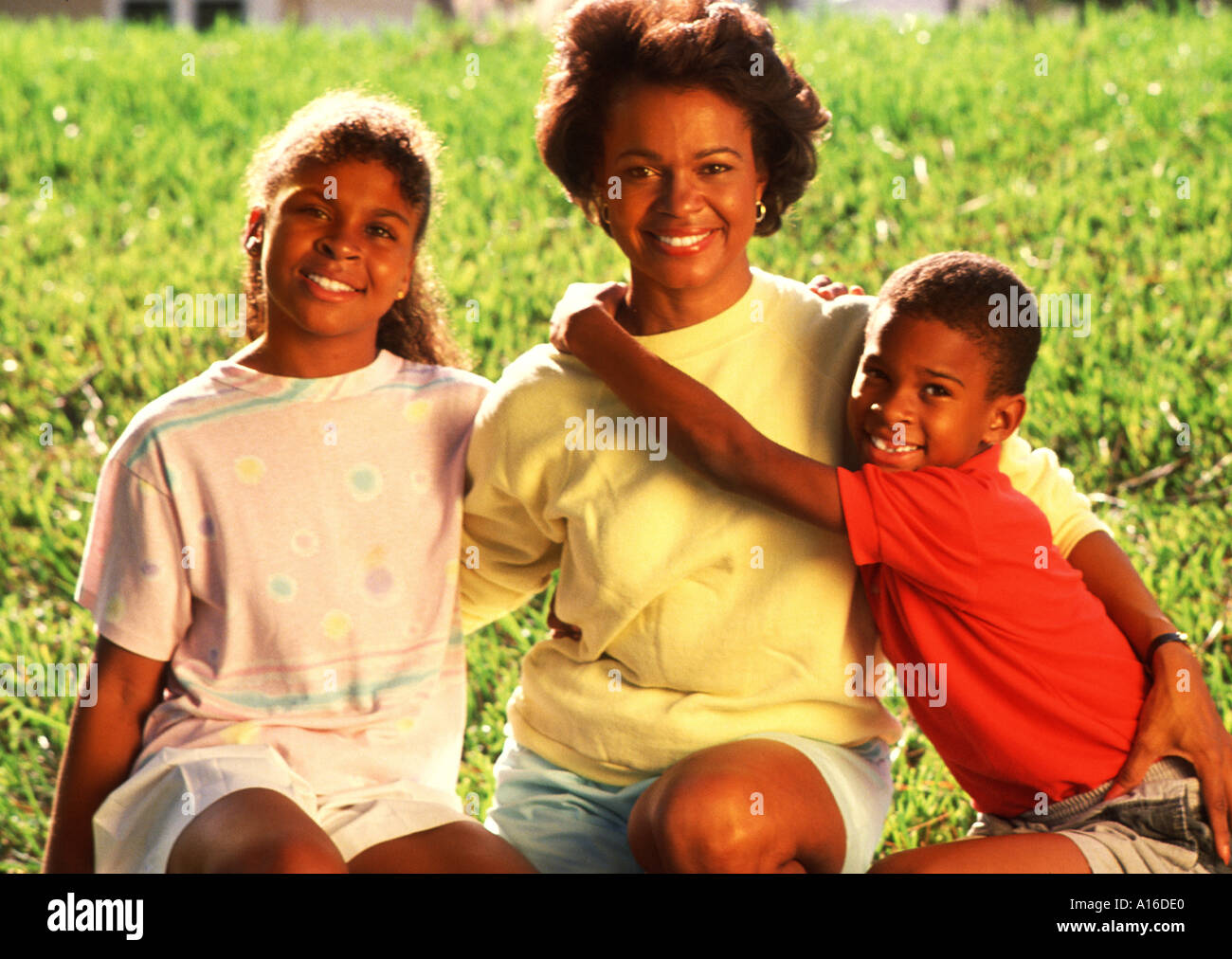 Black African American Mother Daughter And Son Relaxing At Home Outside