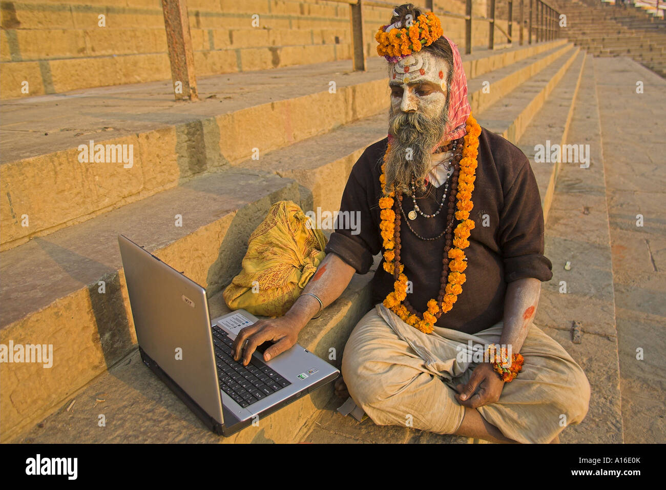 Sadhu working on laptop - India Stock Photo - Alamy